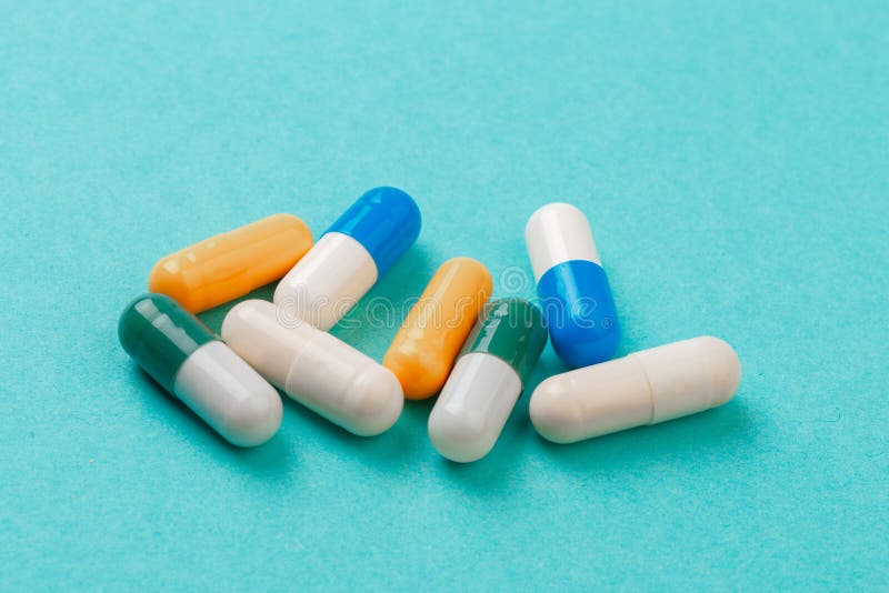 Colour Tablets and Pills on Blue Background Stock Photo - Image of care ...