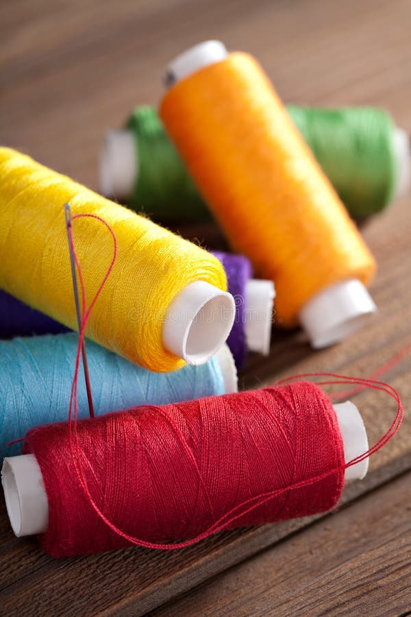 Coloured bobbins of thread stock image. Image of violet - 24369371