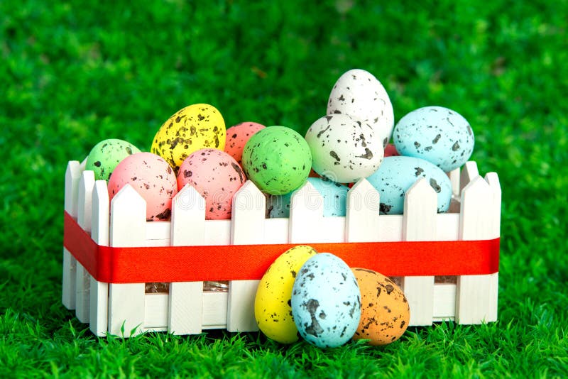 Coloured Eggs in a Fence Box Stock Image - Image of green, ribbon: 68453389