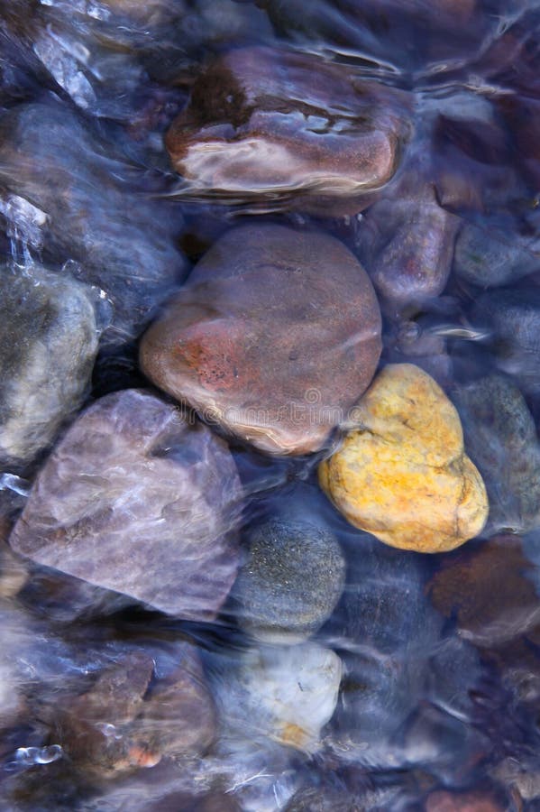 Coloured Pebbles in Running Water Stock Photo - Image of fluid, coast ...