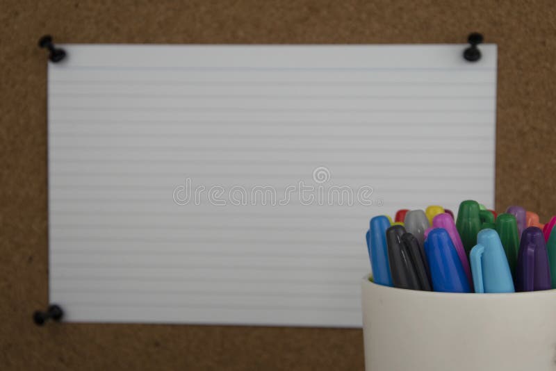 Coloured Pens in Front of Cork Board, Flash Card in Background Stock ...