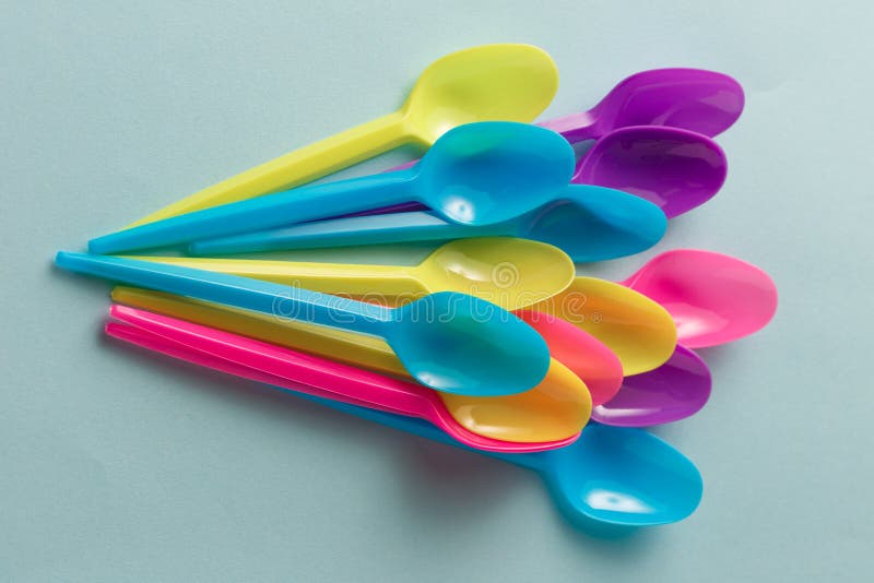 Coloured Plastic Spoons on a Blue Background Stock Photo - Image of ...