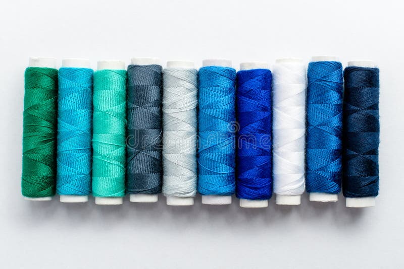 Colourful Blue Spools of Thread Displayed Vertically, Isolated on White ...