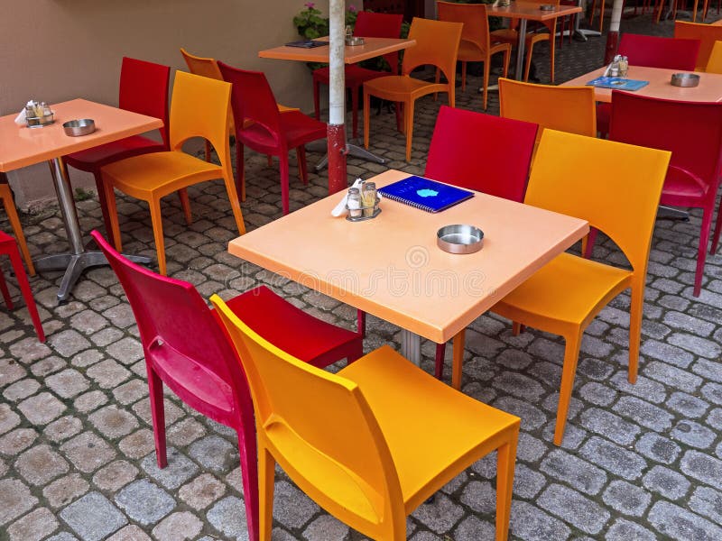 Colourful Cafe Tables stock photo. Image of chairs, outdoor - 76689424