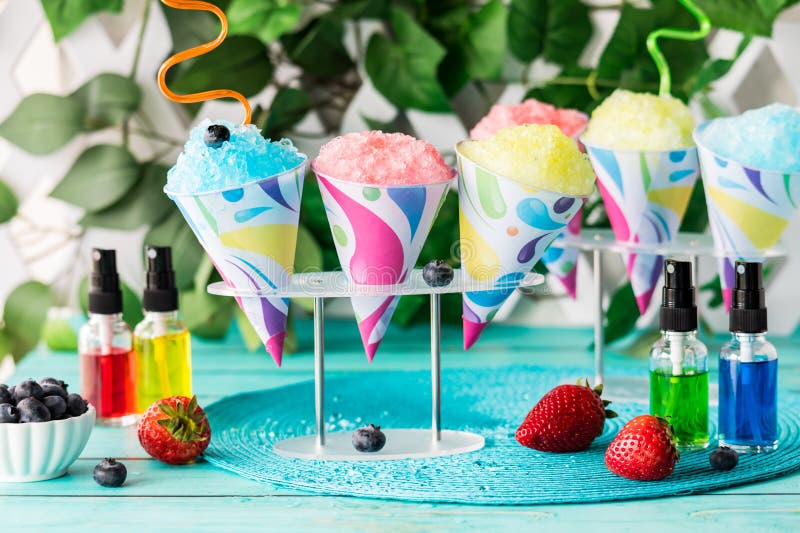 Colourful Flavoured Snow Cones with Fruit Flavoured Syrups in Front ...