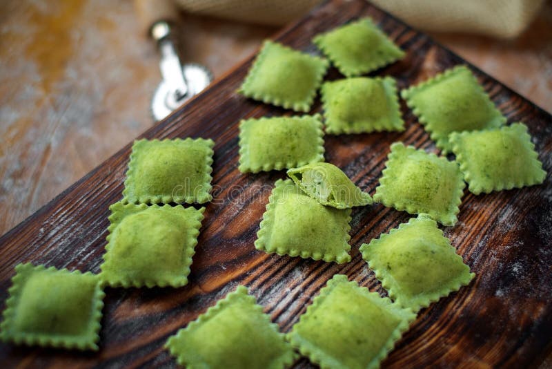 Colourful Fresh Ravioli with Spinach on Board with Flour Stock Photo ...