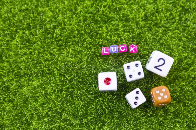 Colourful Luck Cube with Dice Set on Green Grass Background Stock Photo ...