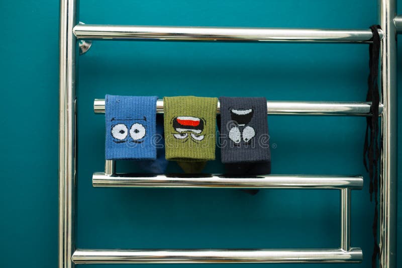 Colourful Old Socks with Funny Faces Drying on a Radiator Stock Image ...