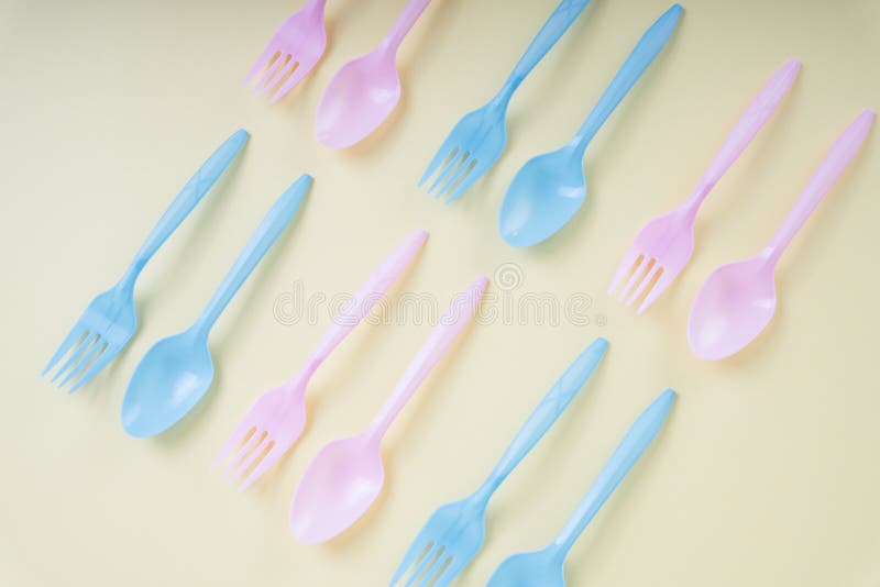 Colourful Pastel Utensil Spoon and Fork Over Bright Yellow Background ...