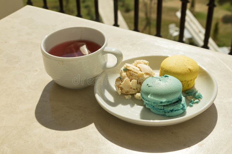 Three Parisian-style Macarons and Cup with Cardamon Tea Stock Image ...