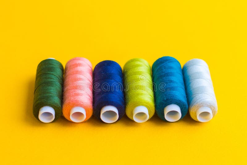 Colourful Thread Spools on a Yellow Background Stock Image - Image of ...