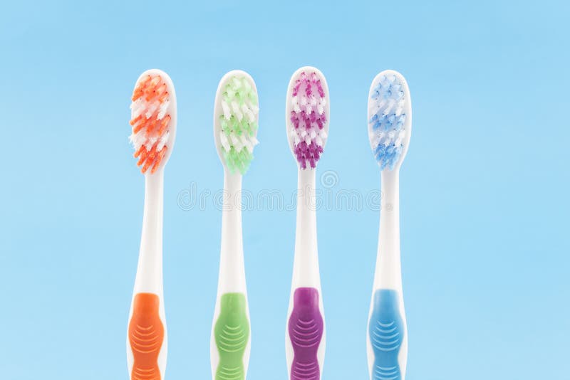 Colourful Toothbrushes Isolated on Blue Stock Photo - Image of ...