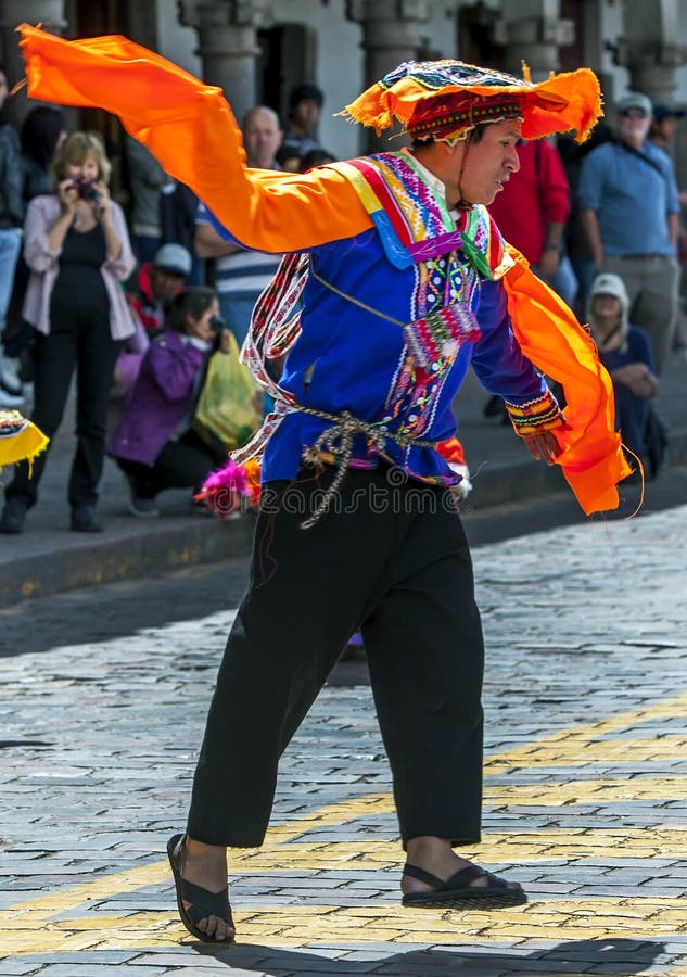 A Colourfully Dressed Man Performs Down a Cusco Street during the May ...