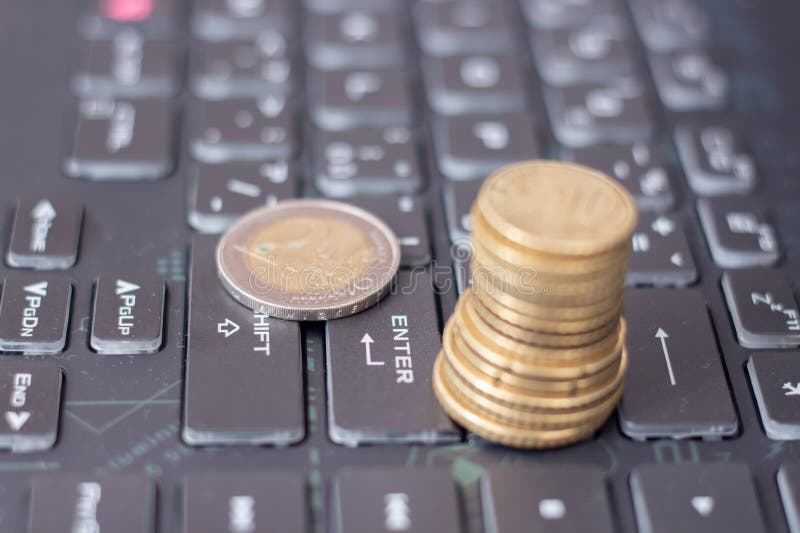 A Column of Coins on a Computer Keyboard. Stock Image - Image of ...