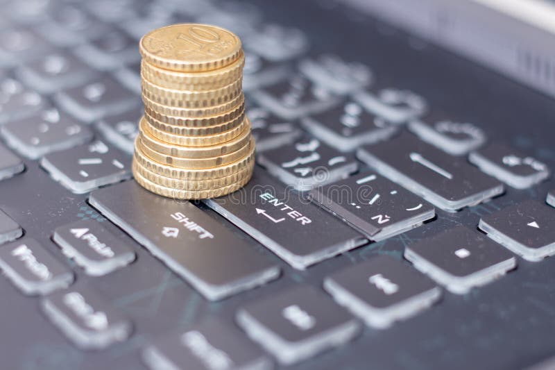 A Column of Coins on a Computer Keyboard. Stock Image - Image of enter ...