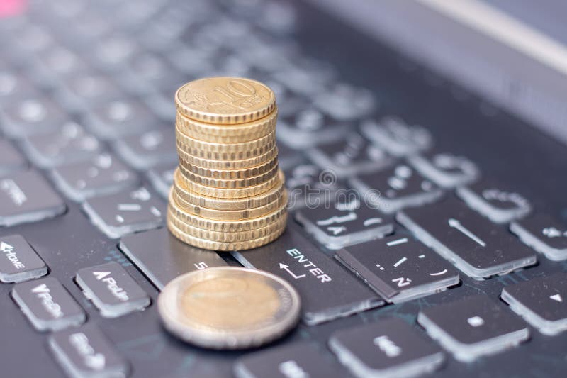 A Column of Coins on a Computer Keyboard. Stock Image - Image of ...