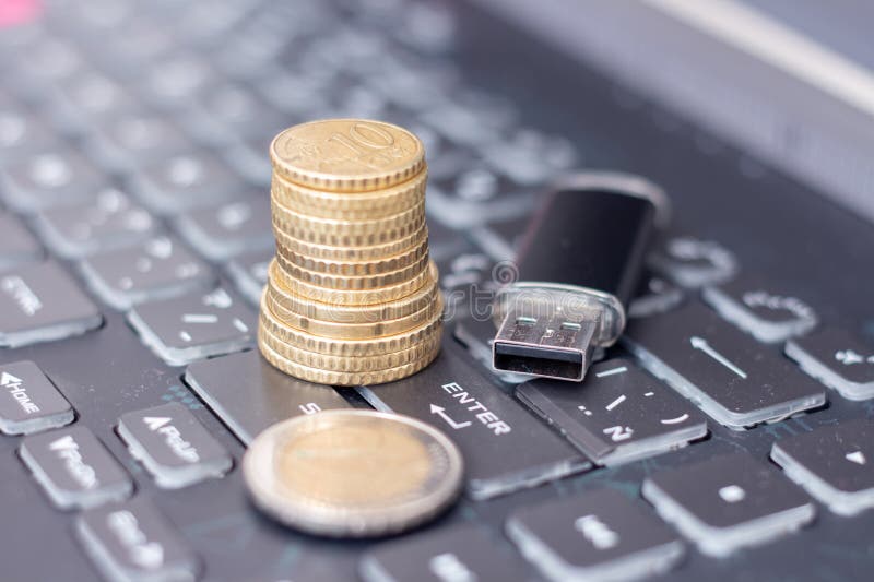 A Column of Coins and a Flash Drive on a Computer Keyboard. Stock Image ...