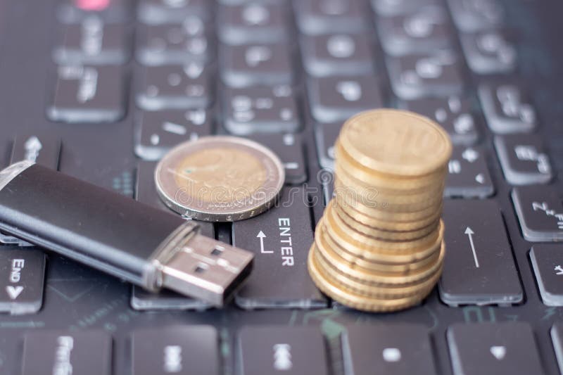 A Column of Coins and a Flash Drive on a Computer Keyboard. Stock Image ...