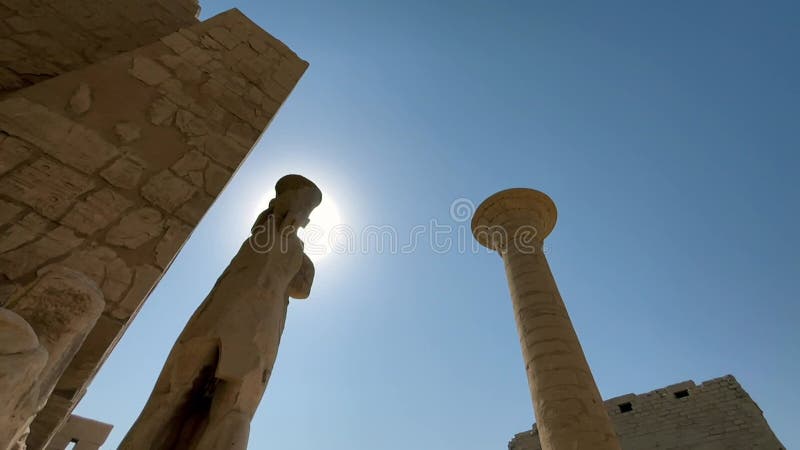 Column and Statue of Karnak S Temple in Front of the Sun Stock Footage ...
