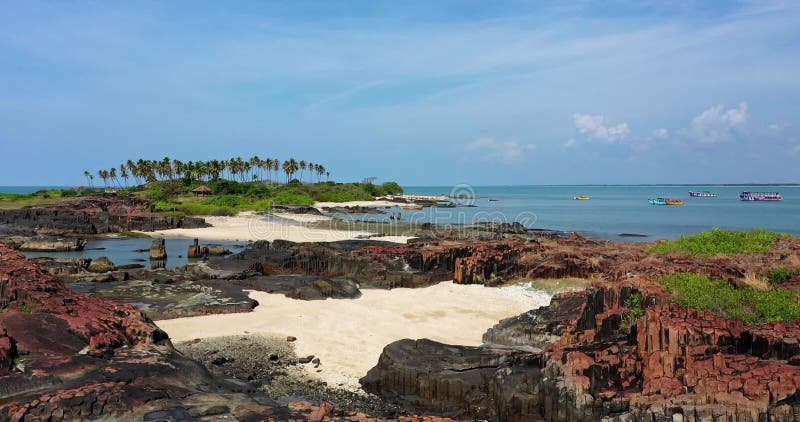 A Columnar Basaltic or Rock Formation with Breaking Waves on Beach ...