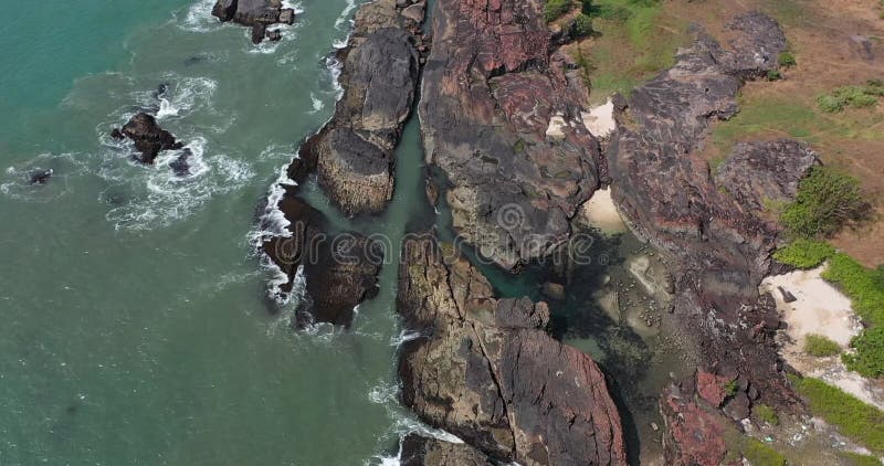 A Columnar Basaltic or Rock Formation with Breaking Waves on Beach ...