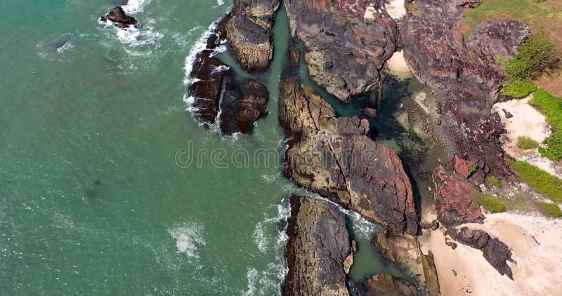 A Columnar Basaltic or Rock Formation with Breaking Waves on Beach ...