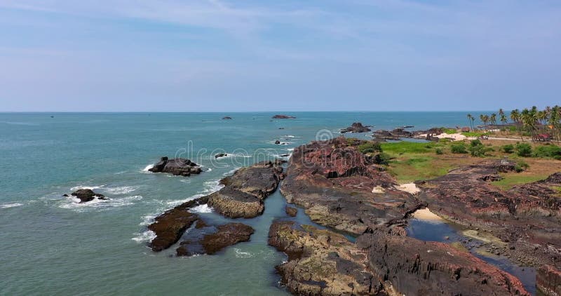 A Columnar Basaltic or Rock Formation with Breaking Waves on Beach ...