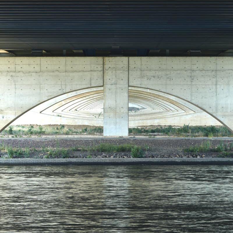 Columns and Arches Arranged One Behind the Other Under a Large Bridge ...