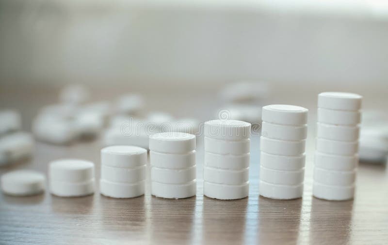 Columns of Tablets on the Table Close-up. the Concept of Increasing the ...