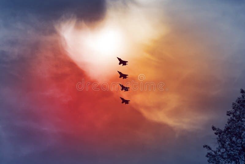 Combat Aircraft Fighters Fly Against the Red Fire Sky. Jet Squadron ...