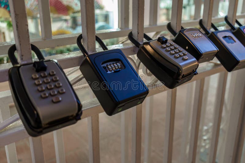 Combination Key Lockboxes Mounted on White Railing Stock Photo - Image ...