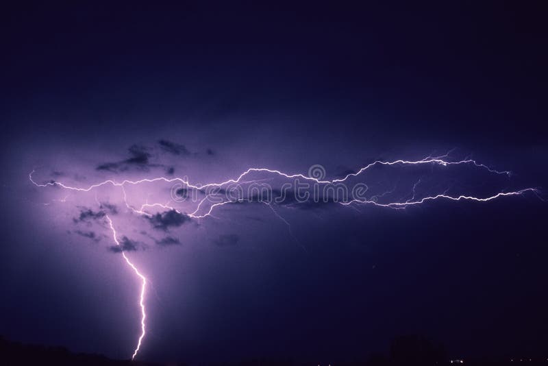 A Strong Flash of Lightning in the Sky while a Strong Storm Hits the ...