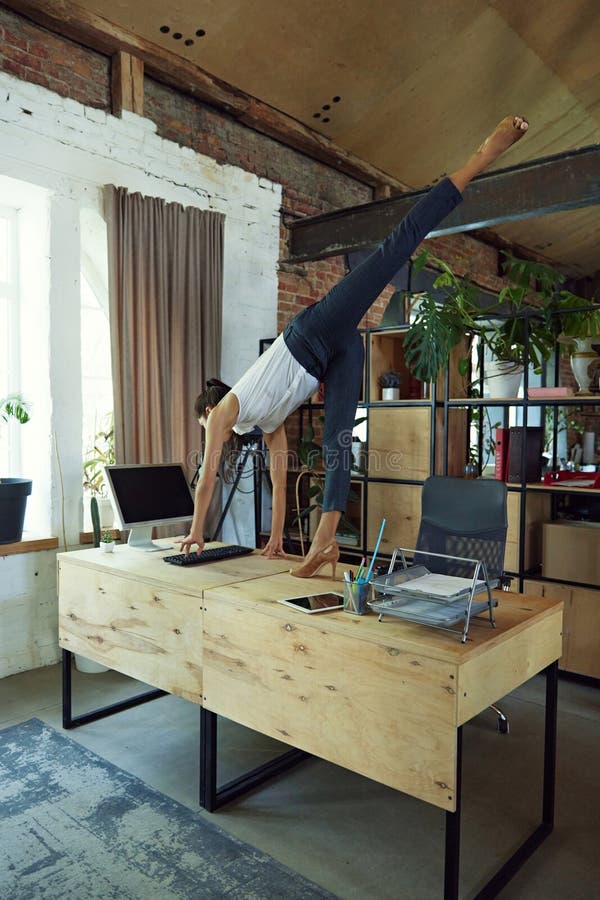 Combination of Work and Exercises. Woman Standing on Desk, Working with ...