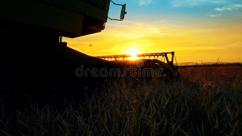 Combine Collecting the Crops at Sunset Stock Image - Image of cinematic ...