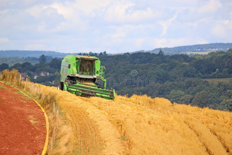 Combine Harvester at work editorial photography. Image of field - 126235997