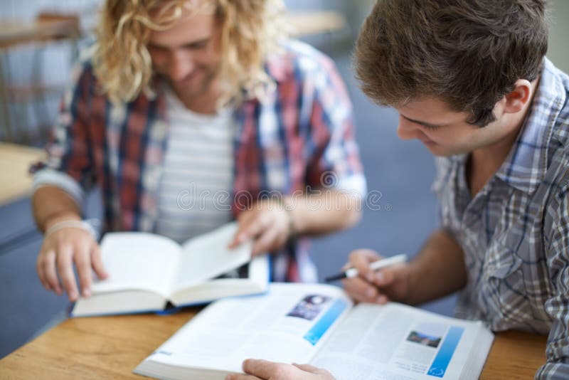 Combining Their Assignment Research. Two Male Students Studying ...