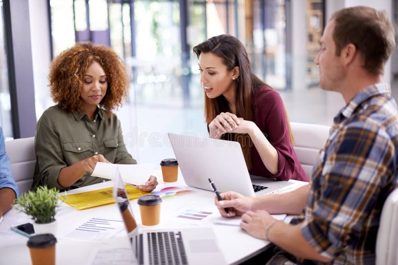 Combining Their Creative Know-how. a Team of Designers Having a Meeting ...