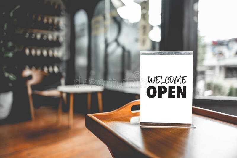 An Open Cafe with a Bar Desk with Wooden Tables and Chairs on the ...