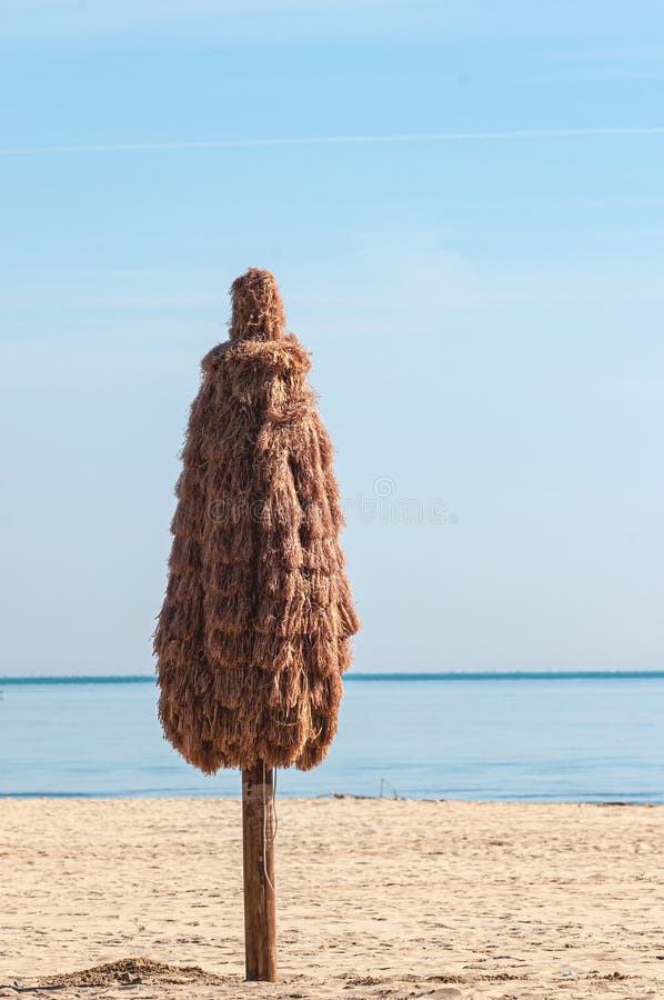 Commercial Beach Umbrella, Closed, on a Sandy Beach, in Early Morning ...