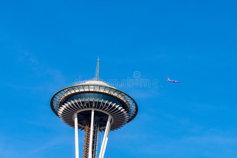 A Comercial Plane Flies Over the Space Needle in Seattle a Comercial ...