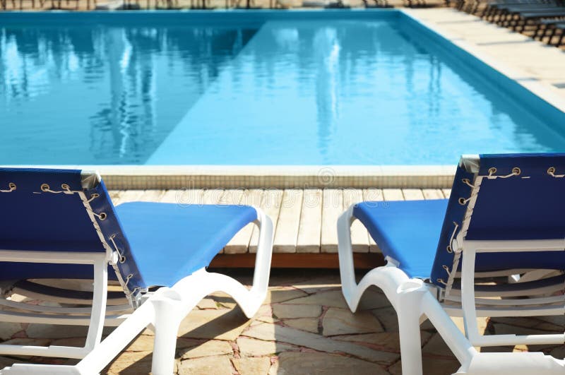 Comfortable Loungers at Clean Pool on Sunny Day Stock Image - Image of ...