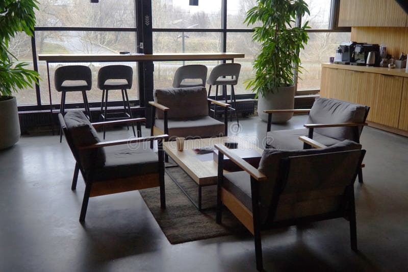 Comfortable Office Interior with Chairs, a Table, and a Kitchen in the ...