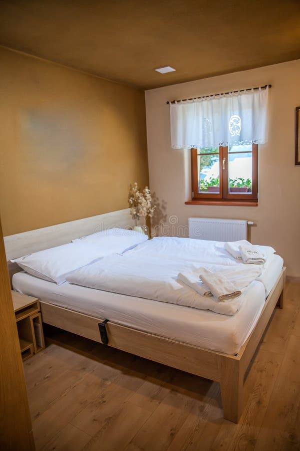 Comfortable Rustic Hotel Room with White Bed Linen at a Nature Park ...
