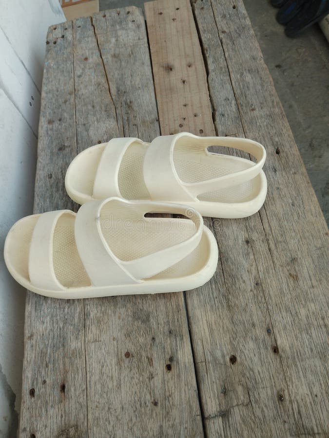 Comfortable Sandals on the Feet, White in Color with a Simple Design ...