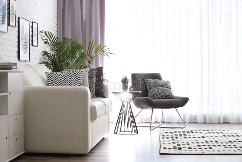 Comfortable Sofa and Chair Near Window with Elegant Curtains in Room ...