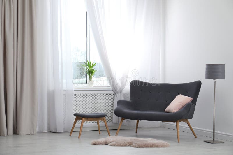 Comfortable Sofa Near Window with Open Curtains in Elegant Room Stock ...