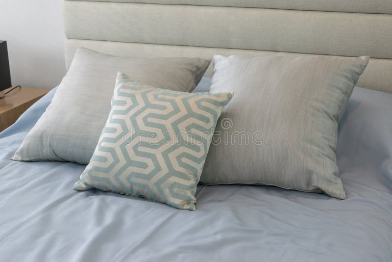 Comfortable Soft Pillows on the Light Blue Bed Stock Photo - Image of ...