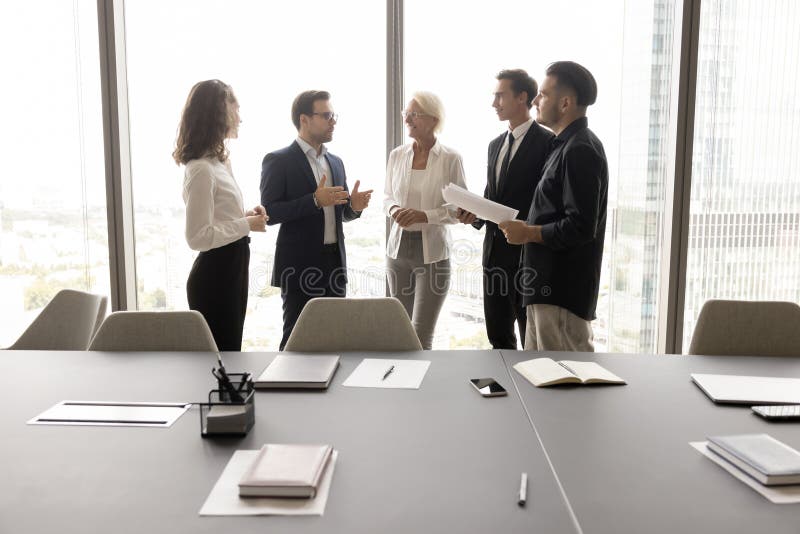 Diverse Workmates Stand at Boardroom Share Ideas in Informal Chat Stock ...