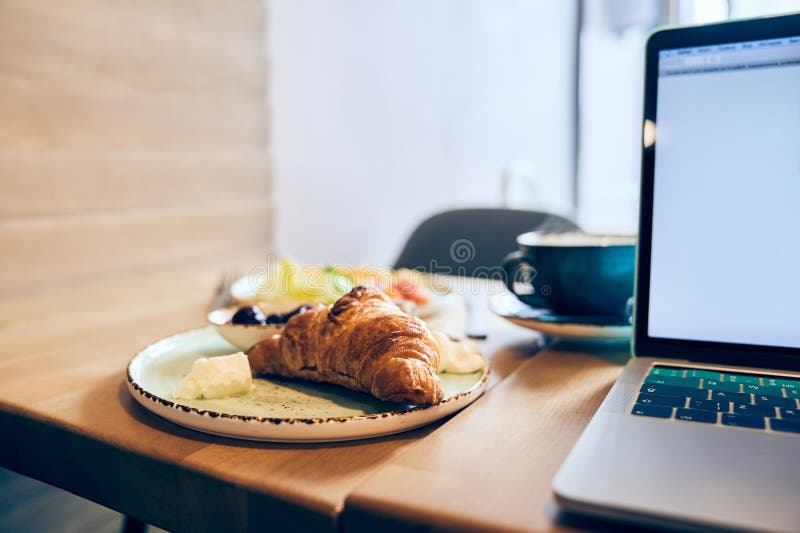 A Comfortable Workplace with a Laptop Computer, with a Cup of Coffee ...