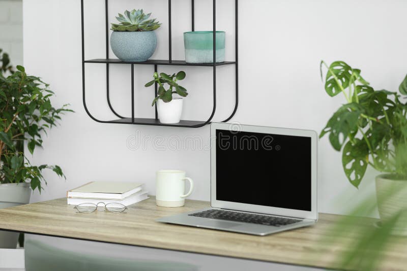 Comfortable Workplace with Modern Laptop on Wooden Table in Room ...